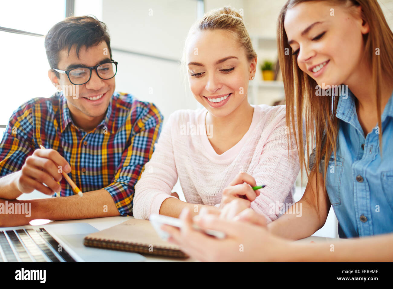 Clever teenage friends doing home assignment together Stock Photo - Alamy
