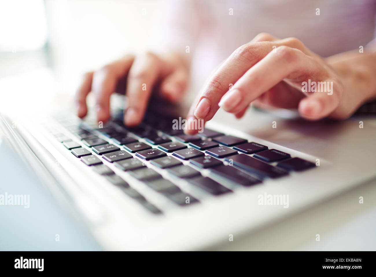 Fingers touching buttons of laptop keypad Stock Photo - Alamy