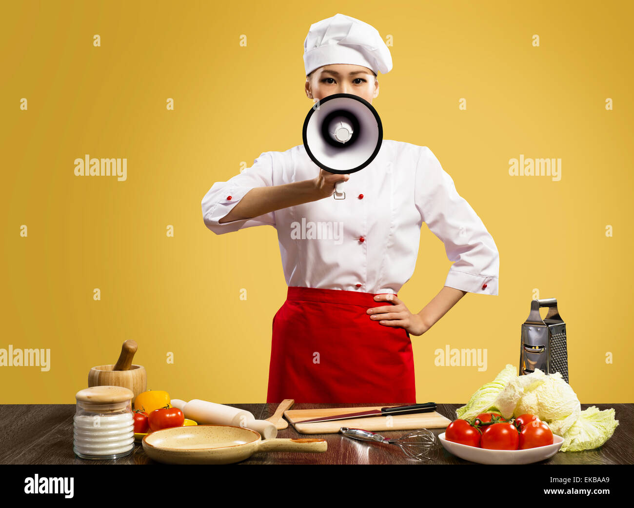 Asian female chef holds a megaphone Stock Photo - Alamy