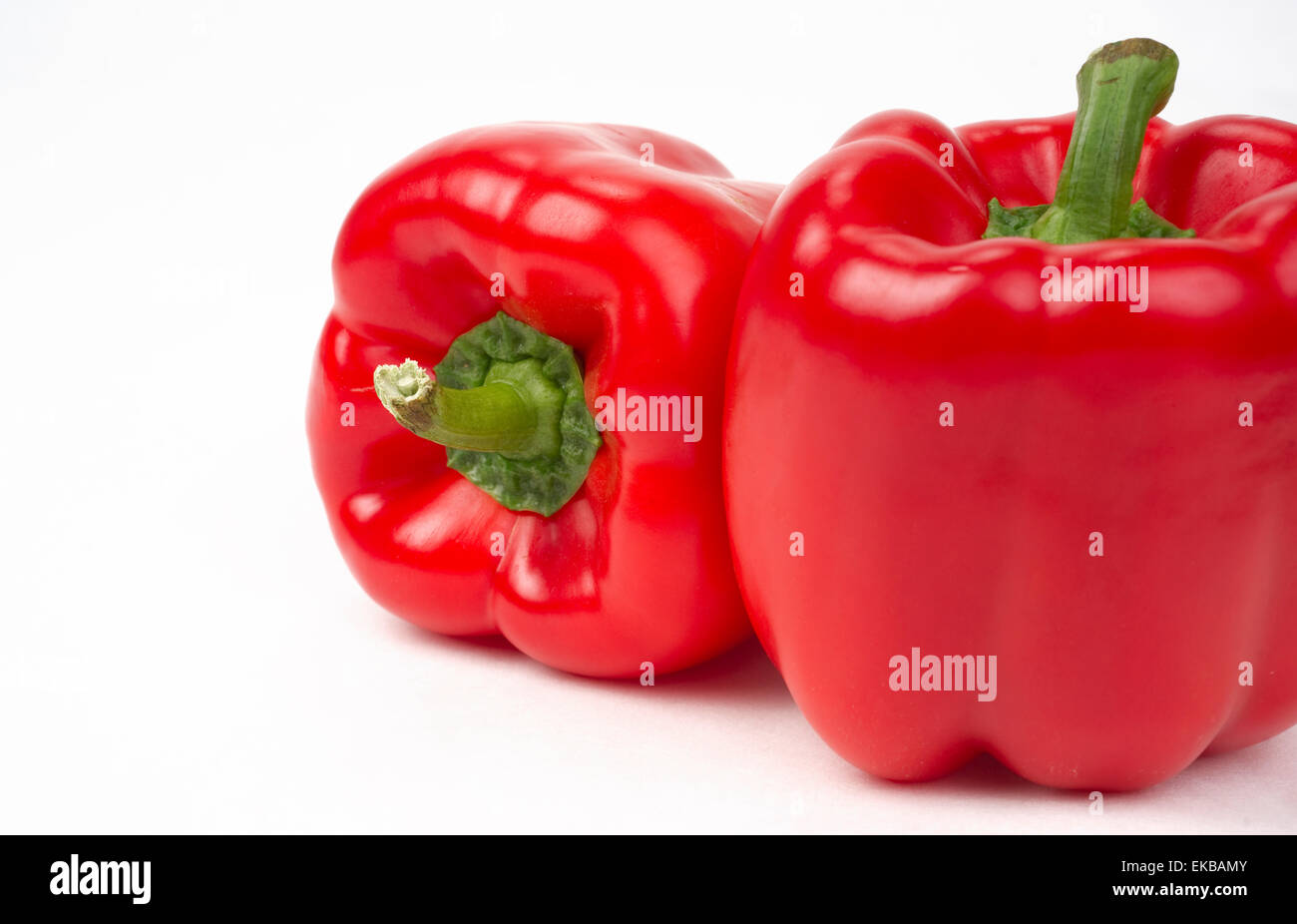 Pair of Bright Fresh Red Peppers Food Sits on White Stock Photo - Alamy