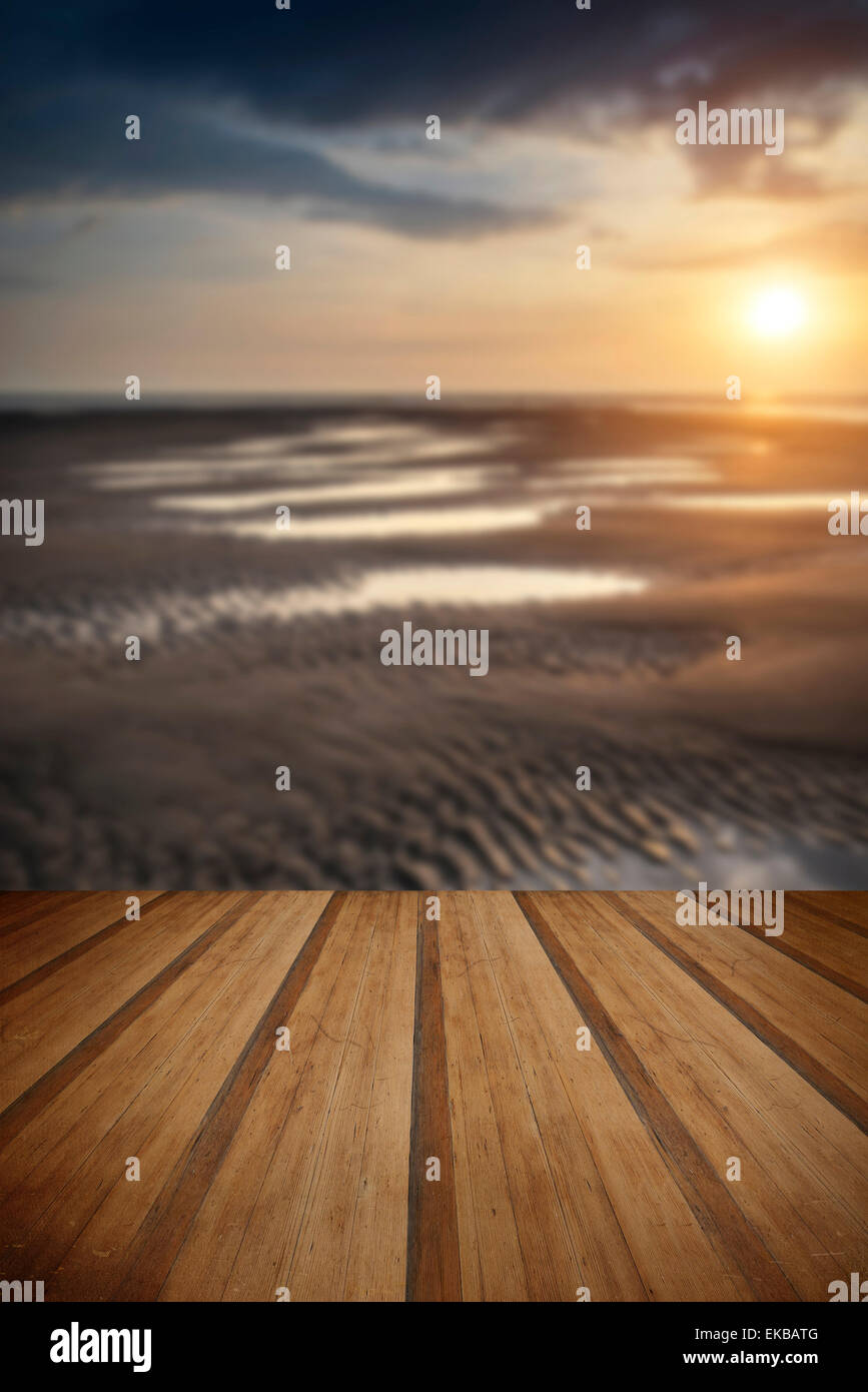 Beautiful Summer sunset over golden beach landscape with wooden planks ...