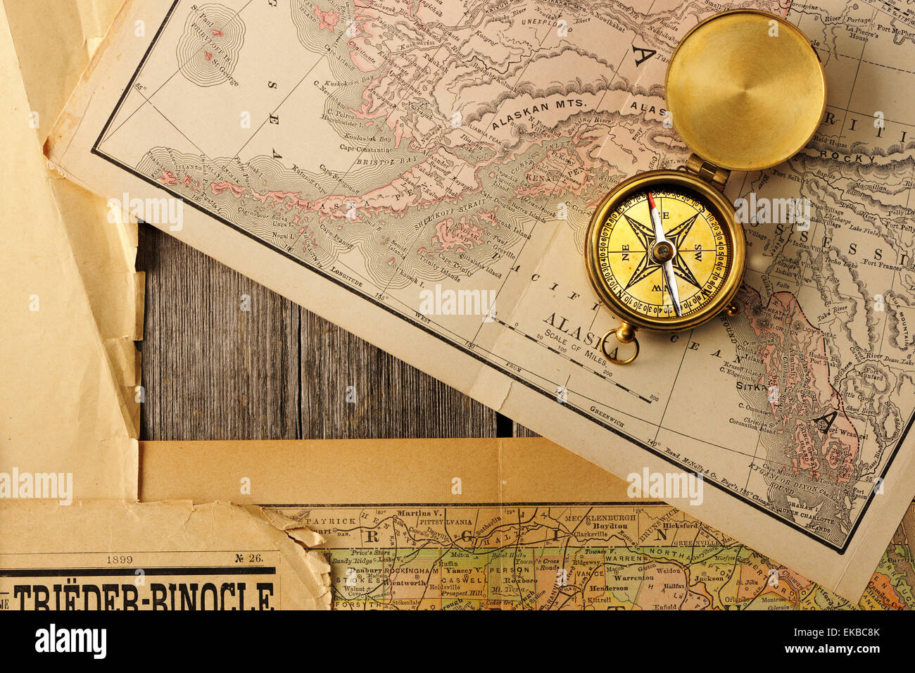 Antique compass over old map Stock Photo - Alamy