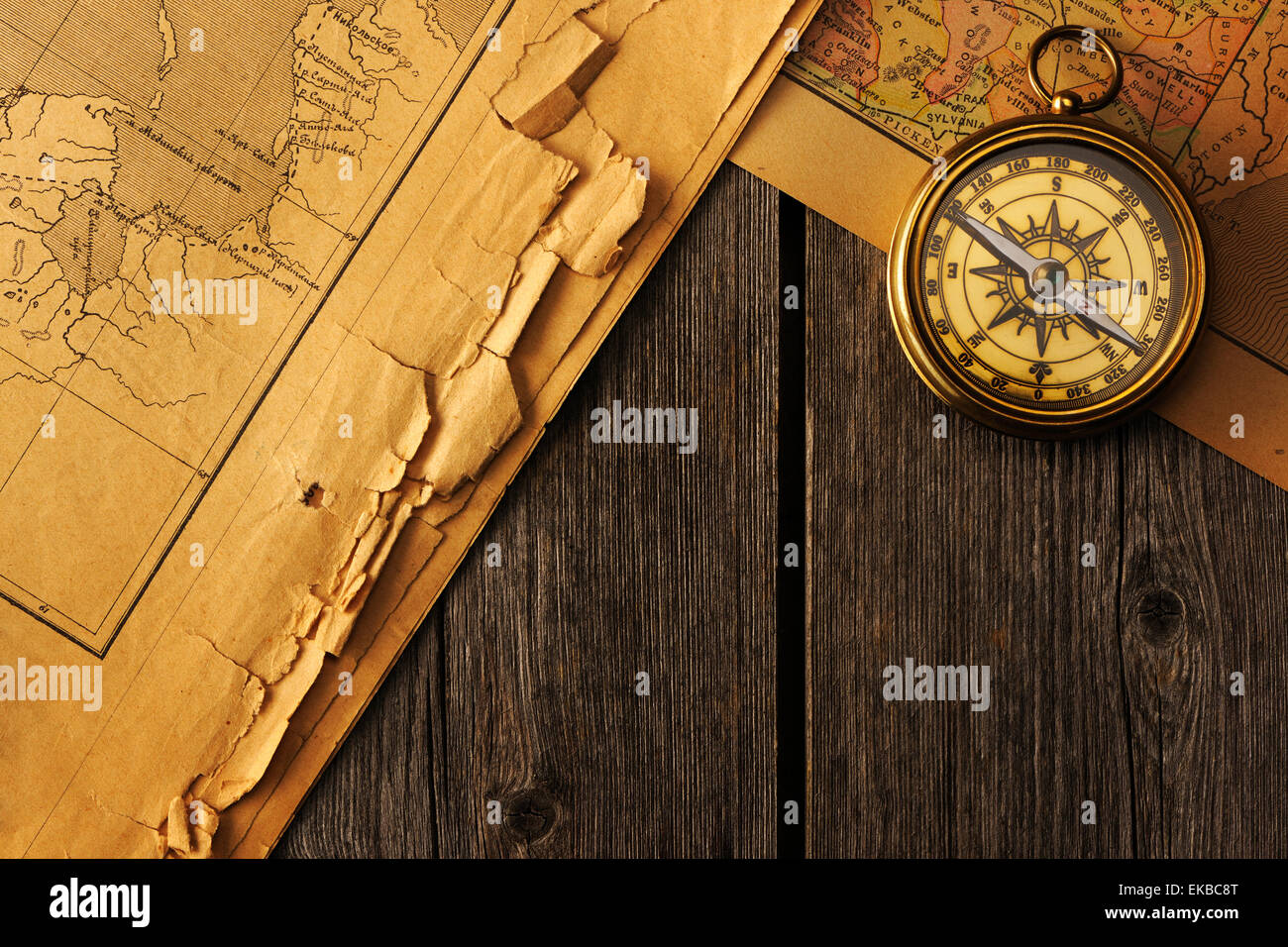 Antique compass over old map Stock Photo - Alamy