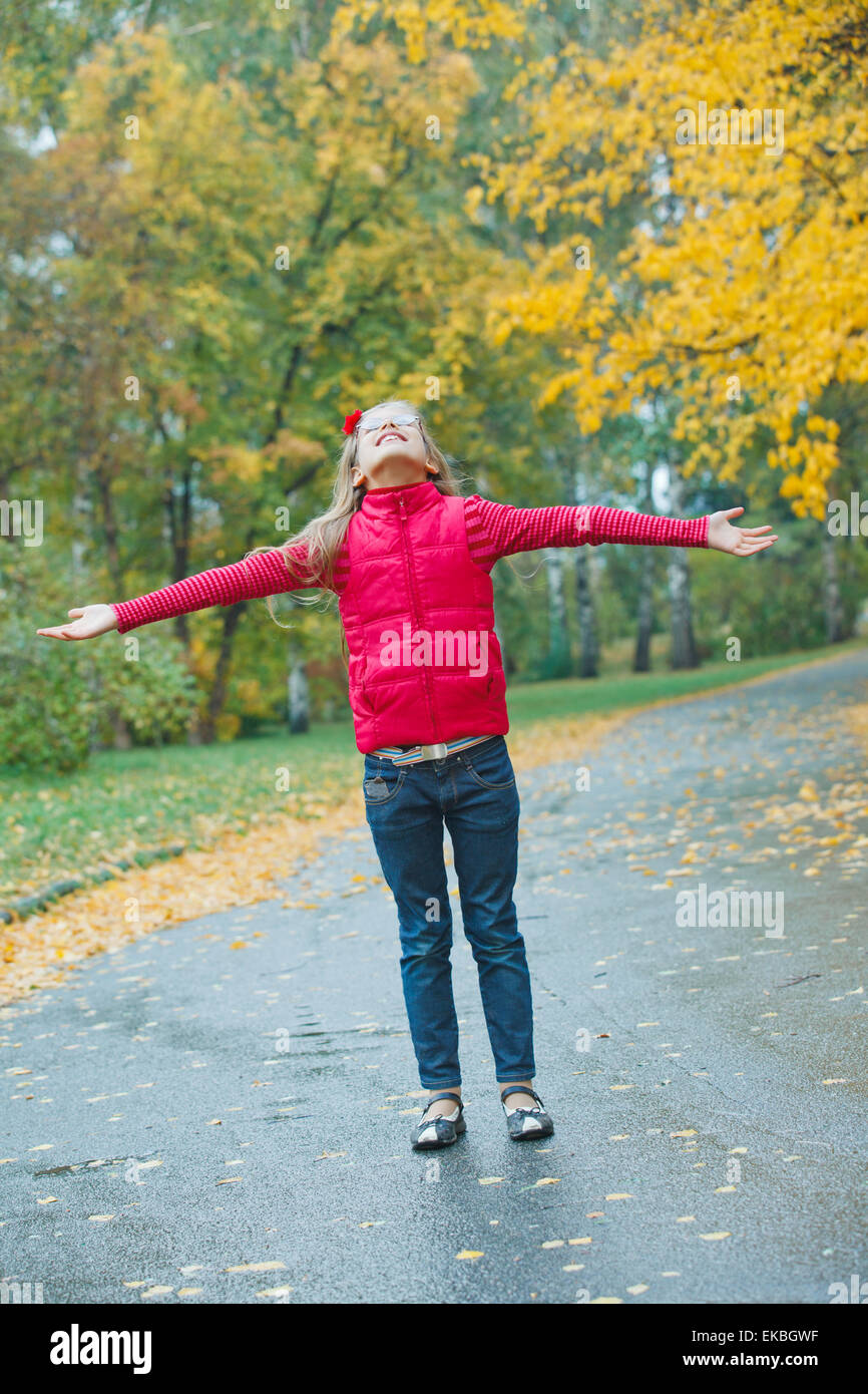 Cute girl walking in the autumn park Stock Photo - Alamy