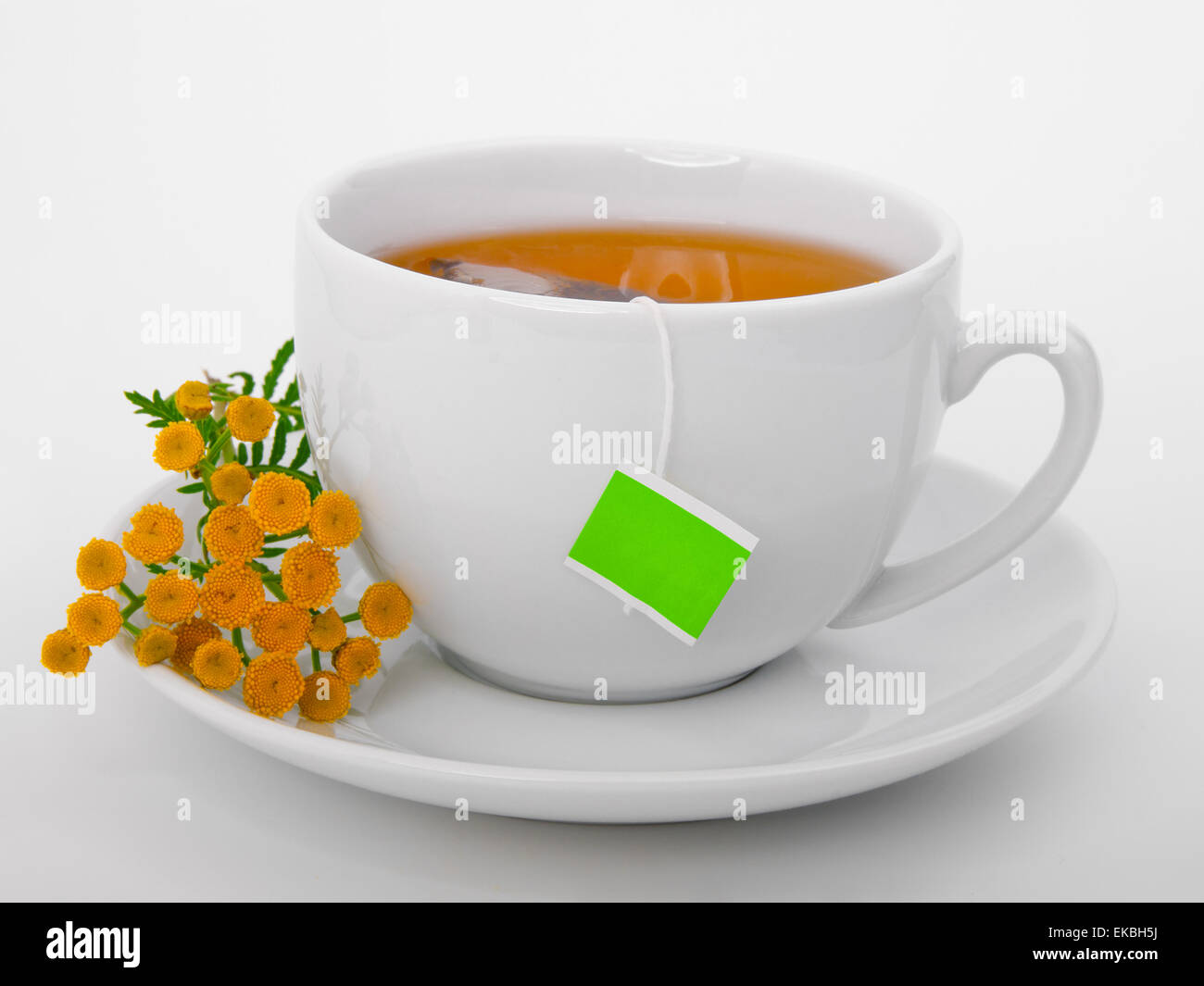 Green tea with tea bag and herb flower. on white background Stock Photo ...