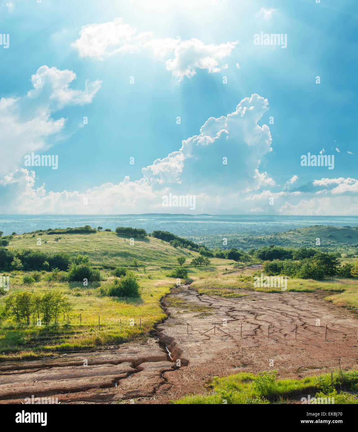 blue sky with clouds and sun over drought earth in mountains Stock ...