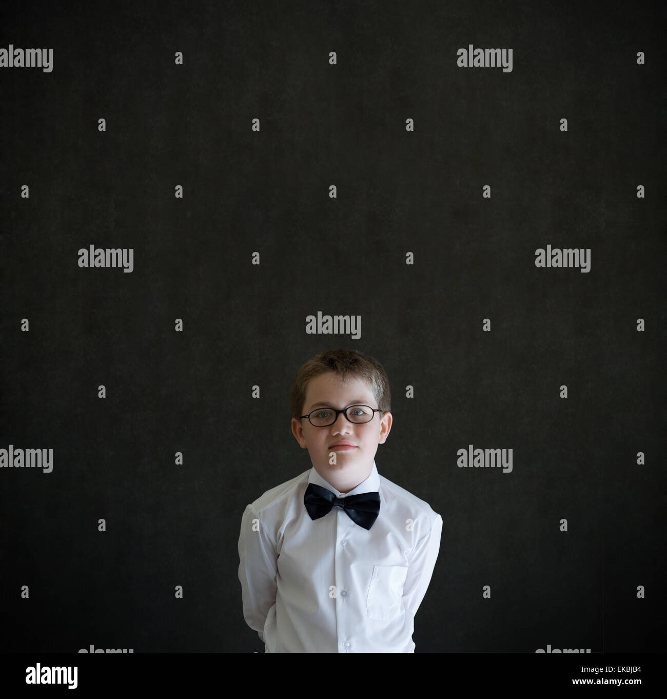 Hands behind back boy dressed up as business man Stock Photo - Alamy