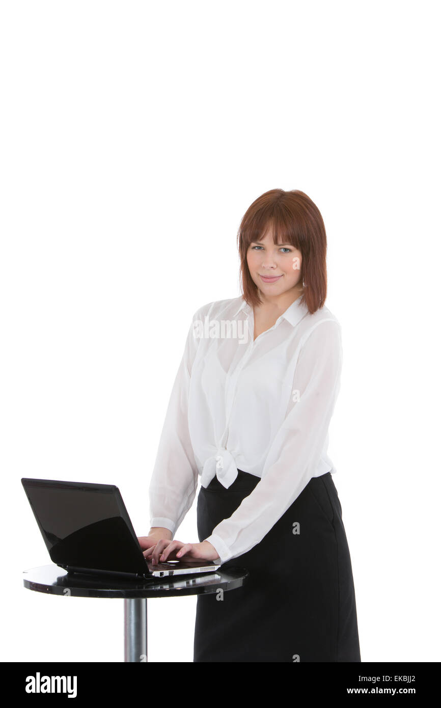 Woman standing typing on her laptop Stock Photo - Alamy