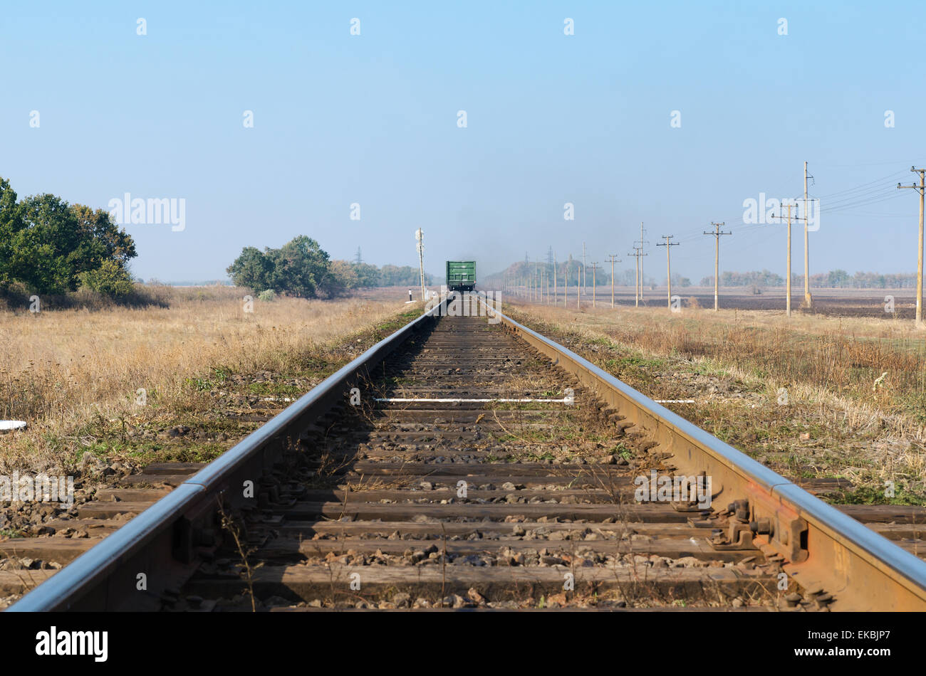 old railroad with train goes to horizon Stock Photo - Alamy