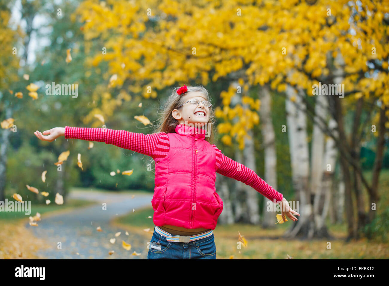 Cute girl walking in the autumn park Stock Photo - Alamy