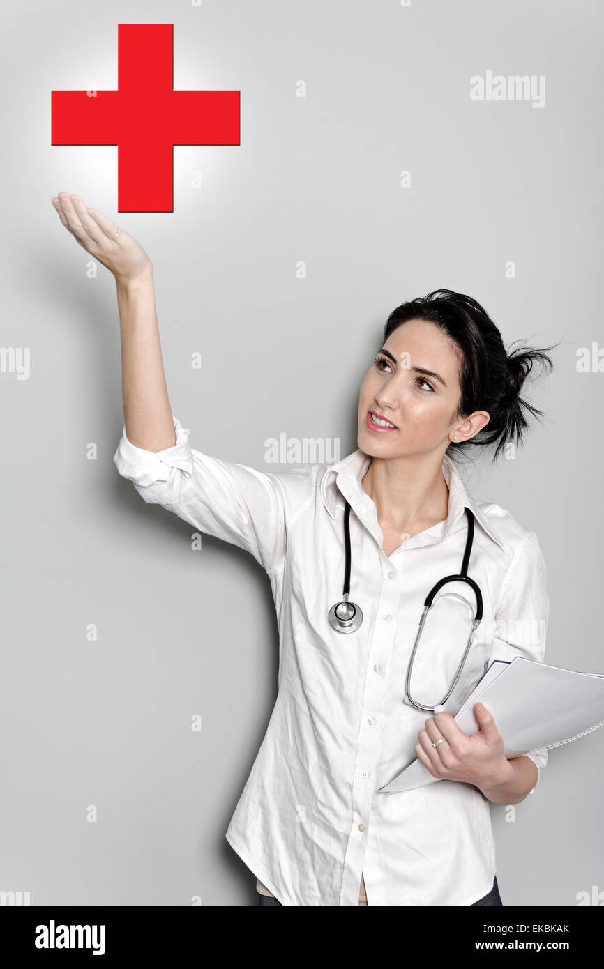 female doctor holding a red cross Stock Photo - Alamy