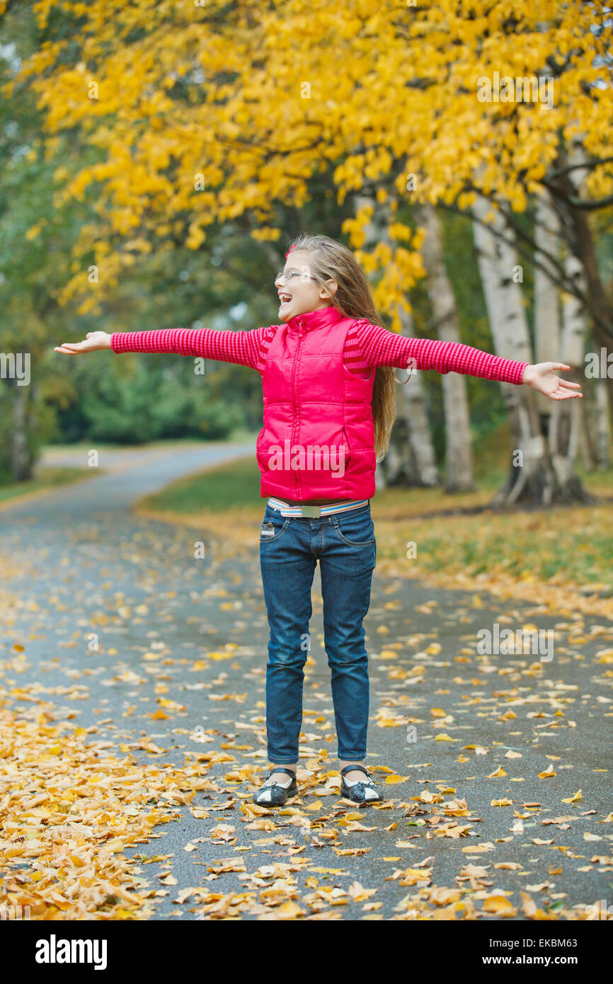 Cute girl walking in the autumn park Stock Photo - Alamy