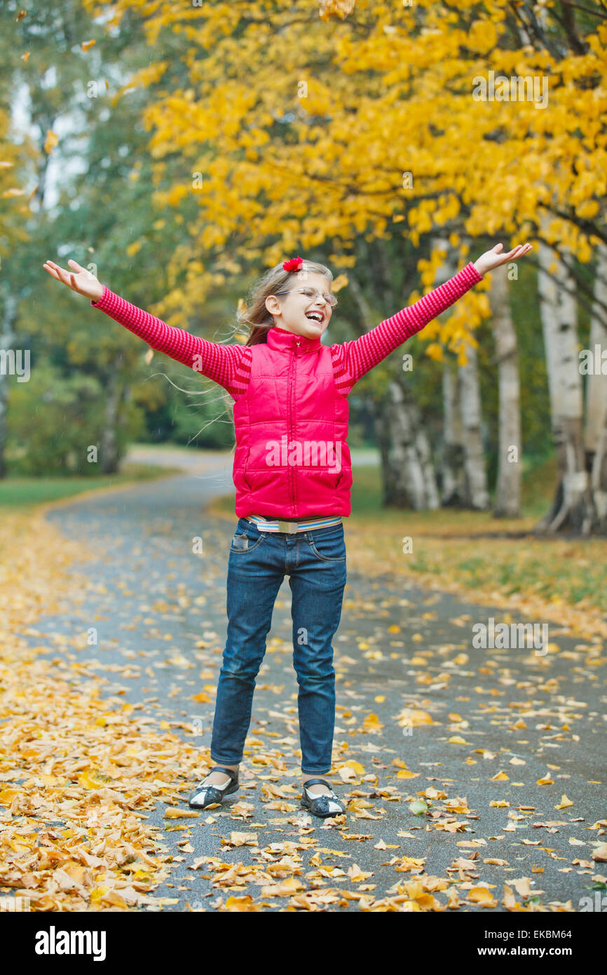 Cute girl walking in the autumn park Stock Photo - Alamy