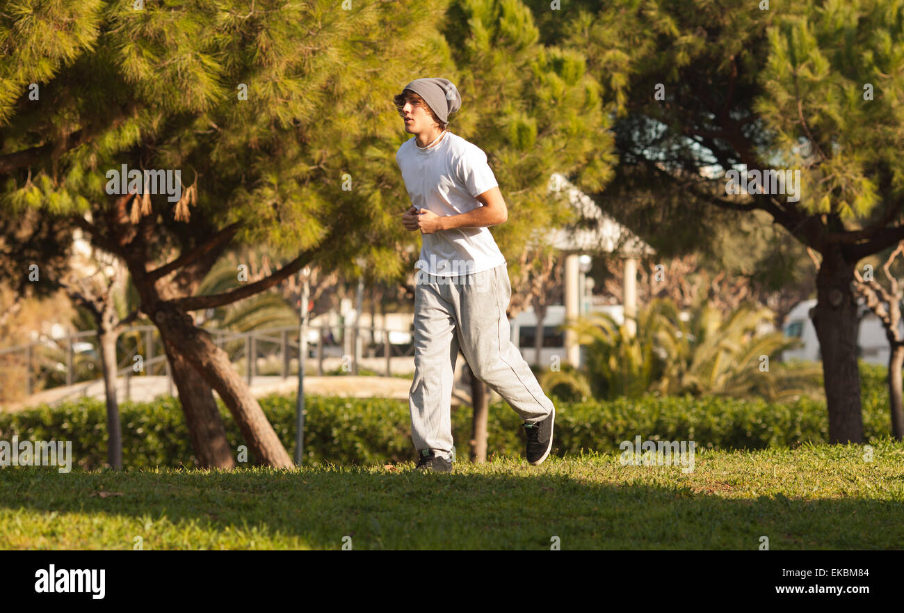 young handsome man jogging in public park Stock Photo - Alamy