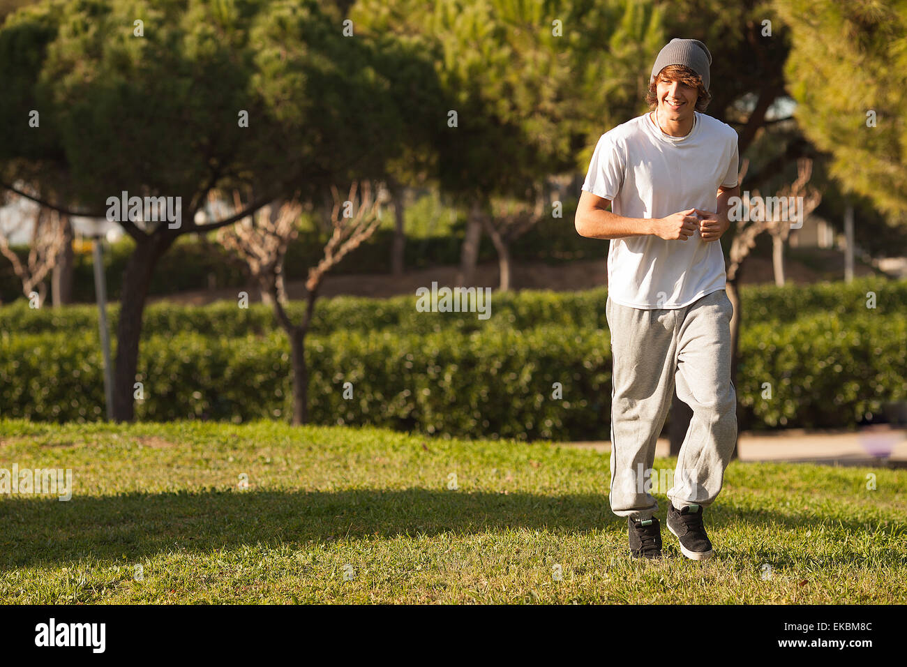 young handsome man jogging in public park Stock Photo - Alamy