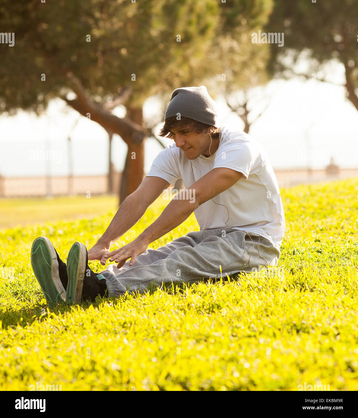 young man portrait stretching after jogging Stock Photo - Alamy