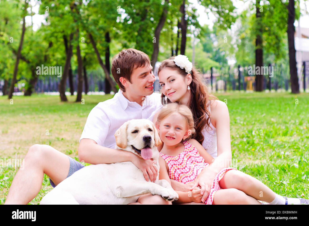 Happy young family with Labrador Stock Photo - Alamy