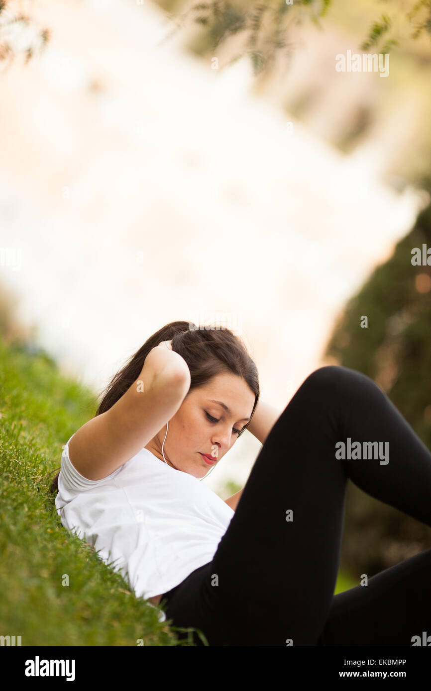 young beautiful latin woman making abs Stock Photo - Alamy