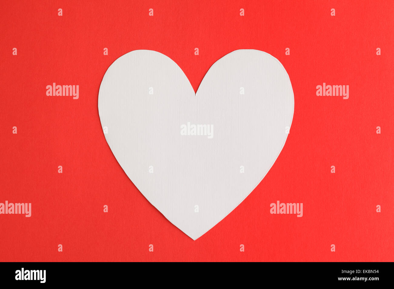 Heart shape paper over red paper background Stock Photo - Alamy