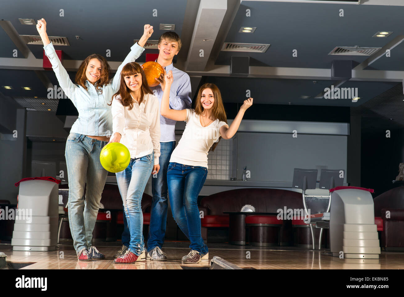 Group of young friends playing bowling Stock Photo - Alamy