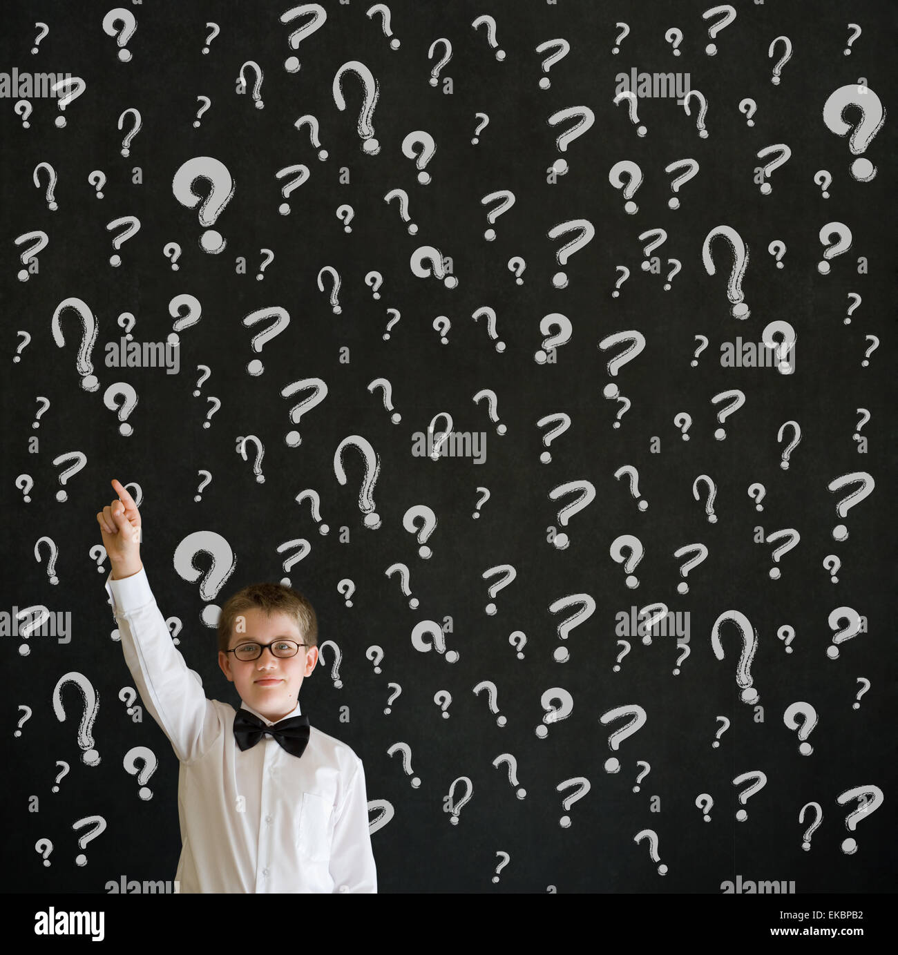 Hand up answer boy dressed as business man with chalk question marks ...