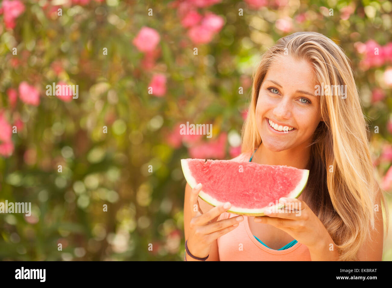 Portrait of a beautiful young woman eating watermelon Stock Photo - Alamy