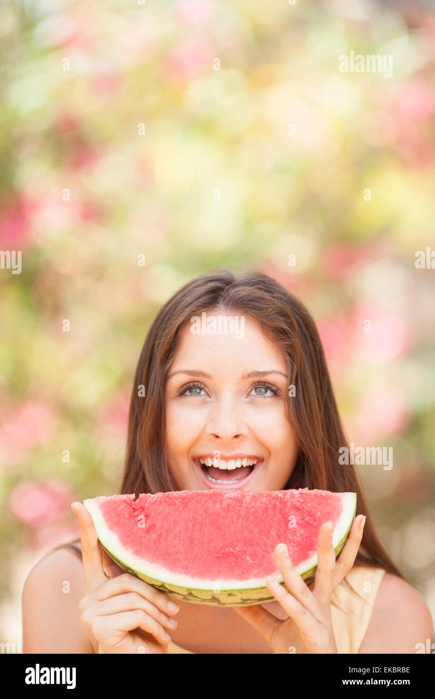 Portrait of a beautiful young woman eating watermelon Stock Photo - Alamy