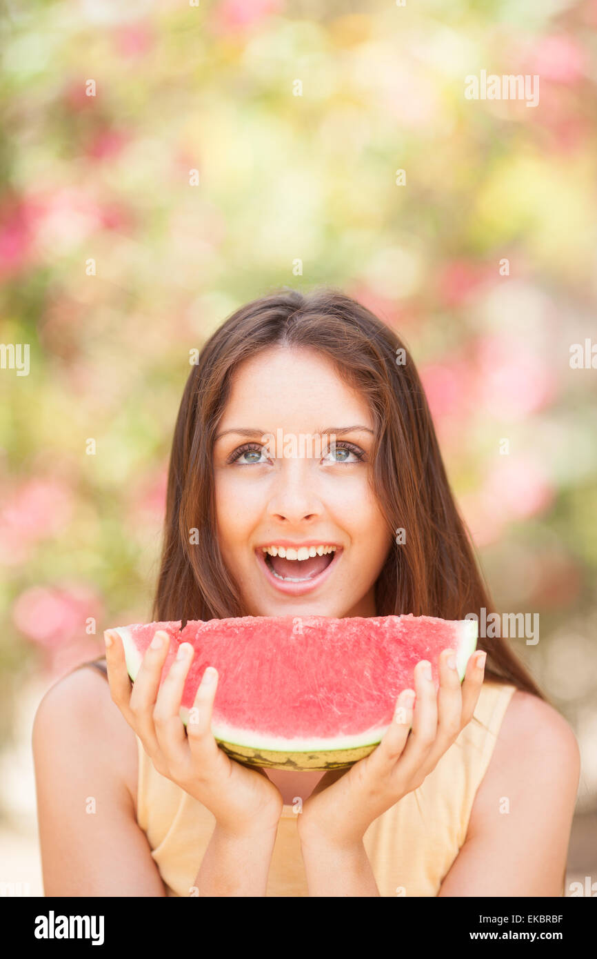 Portrait of a beautiful young woman eating watermelon Stock Photo - Alamy