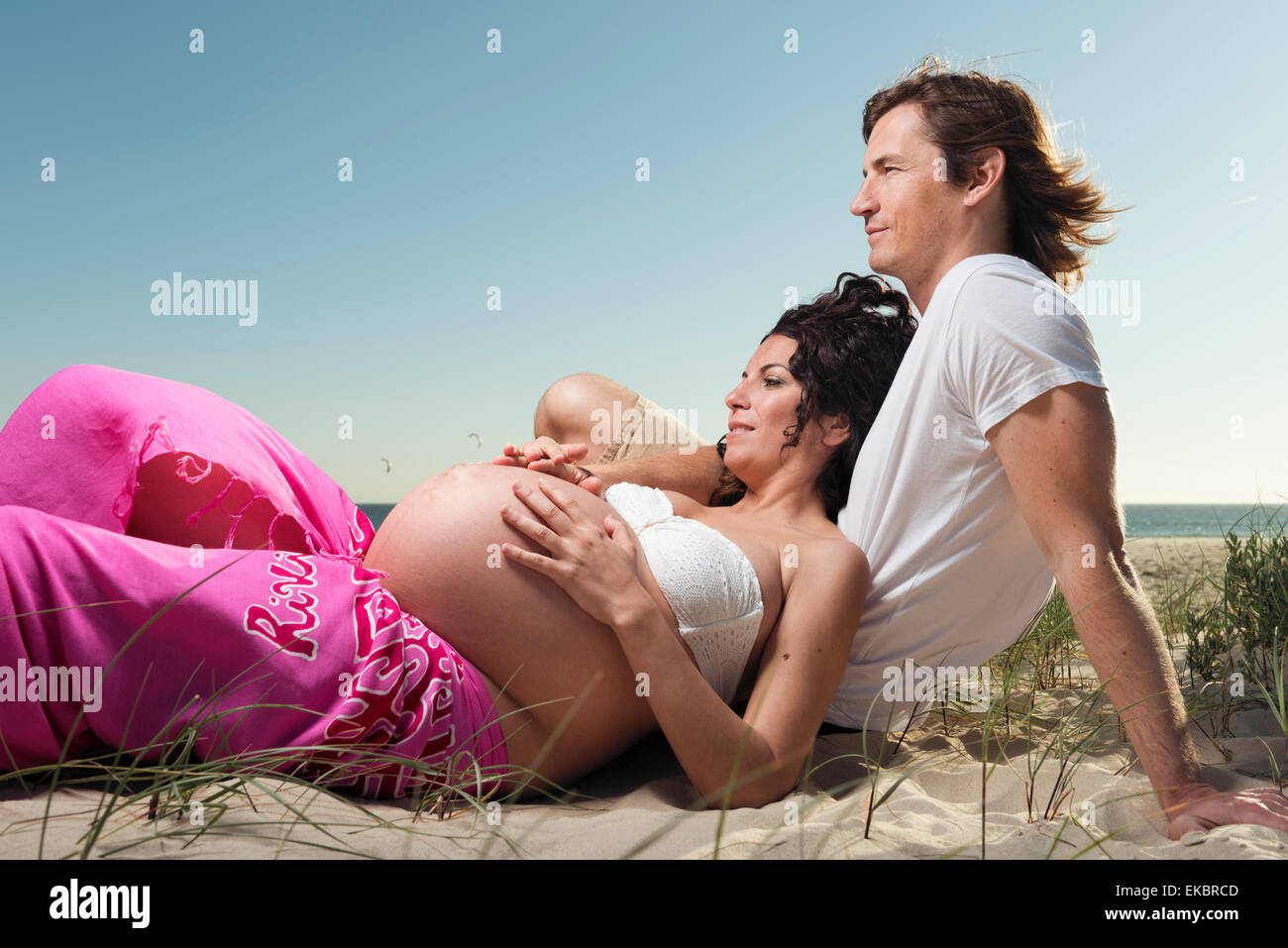 Pregnant Couple Relaxing At The Beach Stock Photo Alamy
