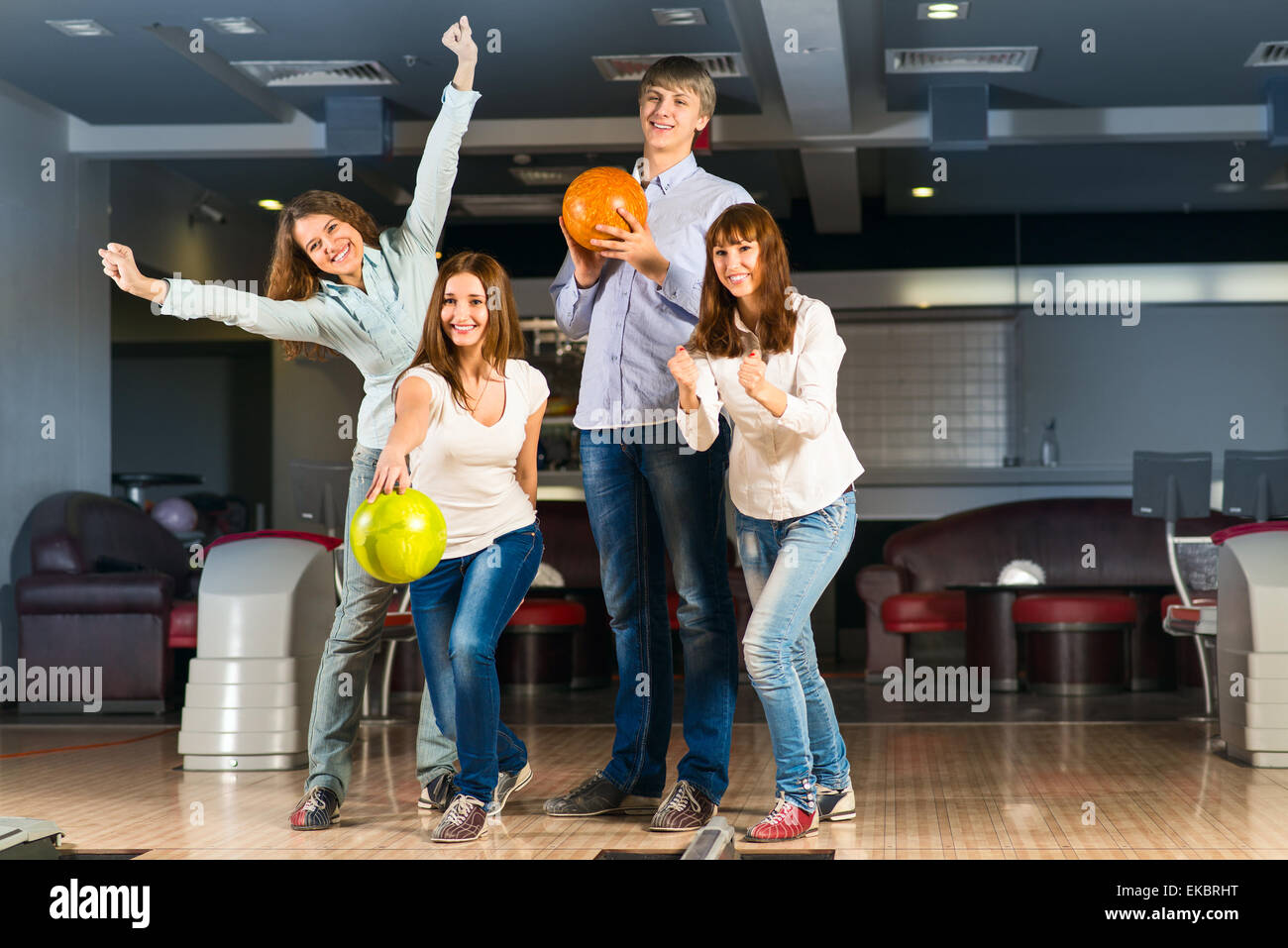 Group of young friends playing bowling Stock Photo - Alamy