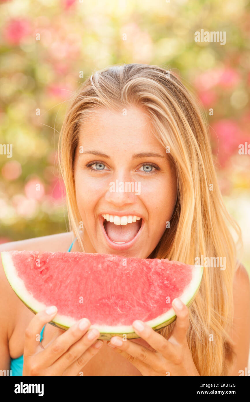 Portrait of a beautiful young woman eating watermelon Stock Photo - Alamy