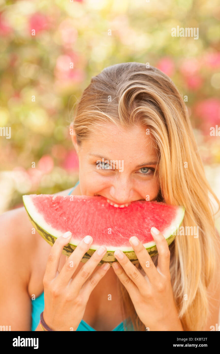 Portrait of a beautiful young woman eating watermelon Stock Photo - Alamy