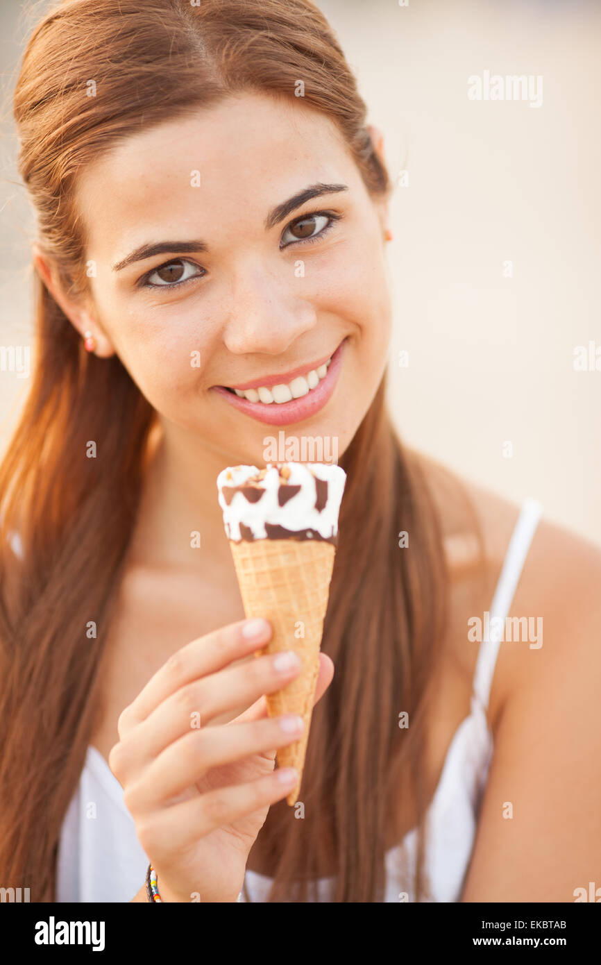 portrait of a young beautiful woman eating ice-cream cone Stock Photo ...