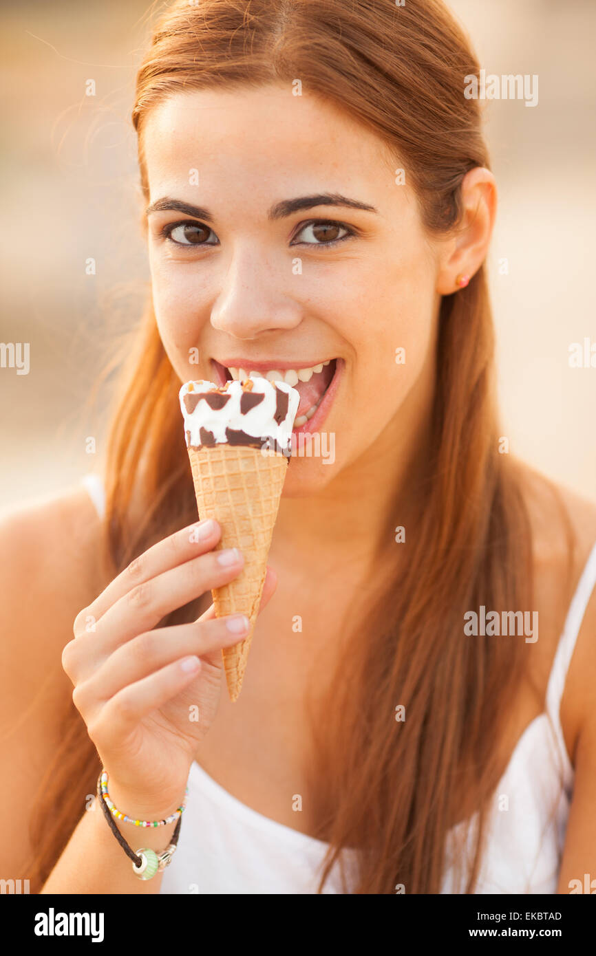 portrait of a young beautiful woman eating ice-cream cone Stock Photo ...