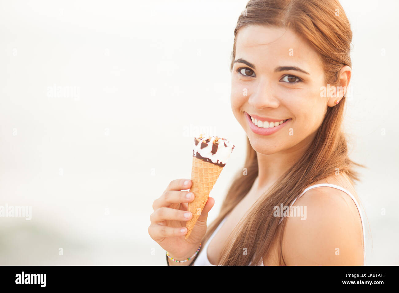 portrait of a young beautiful woman eating ice-cream cone Stock Photo ...