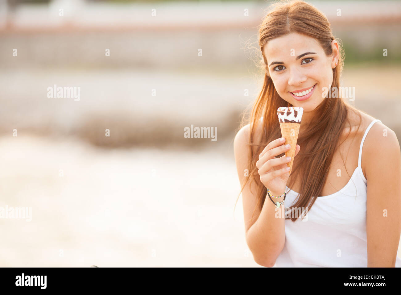 portrait of a young beautiful woman eating ice-cream cone Stock Photo ...
