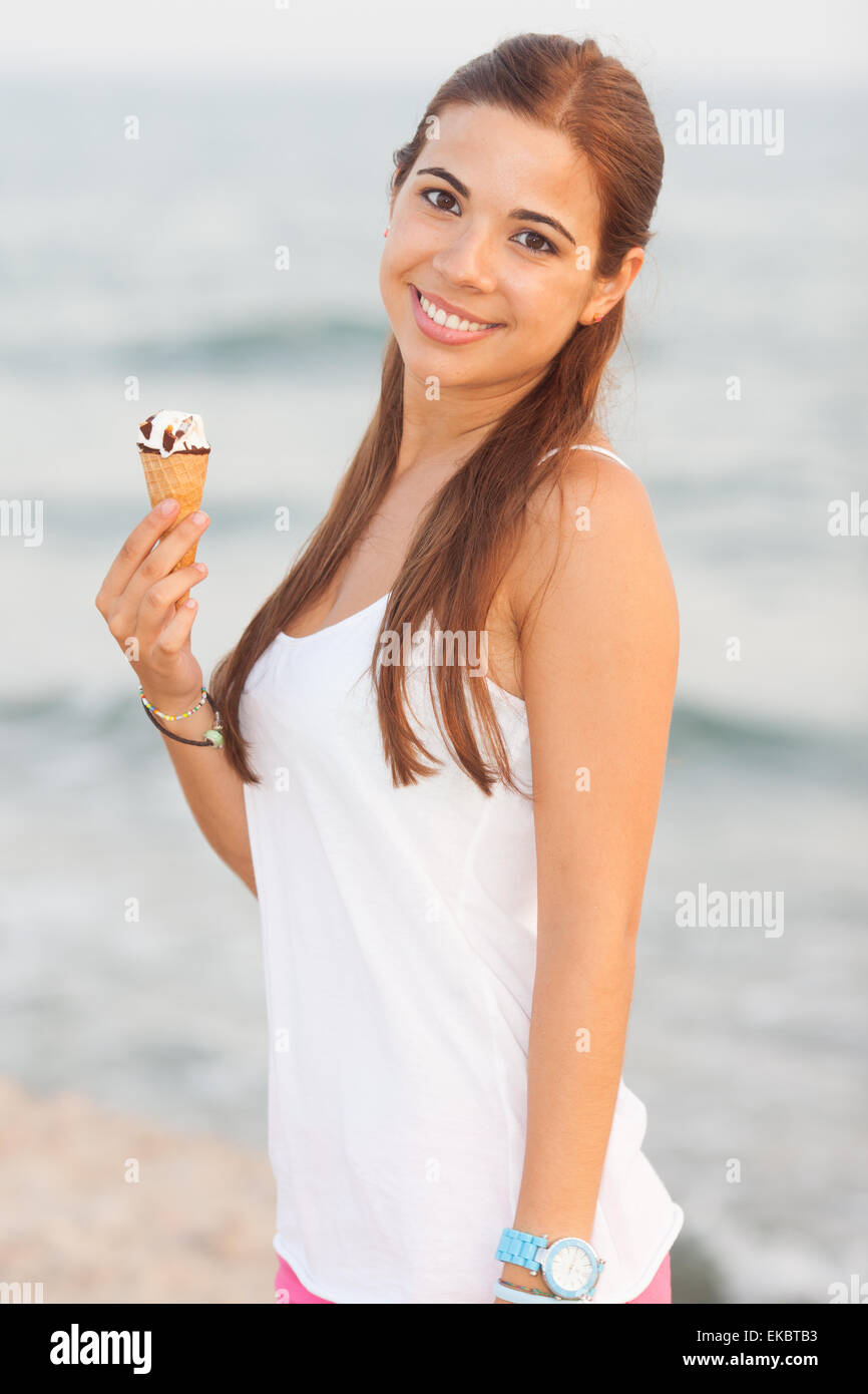 portrait of a young beautiful woman eating ice-cream cone Stock Photo ...