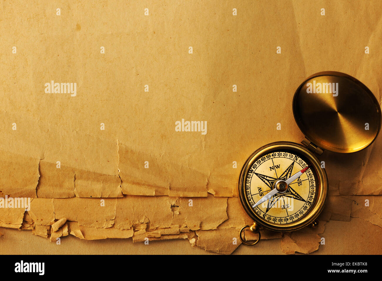 Antique brass compass over old background Stock Photo - Alamy