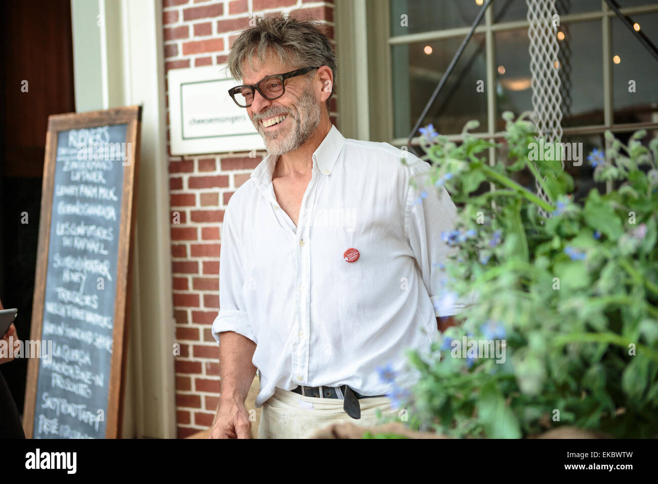 Farmer selling organic food on stall outside store Stock Photo - Alamy
