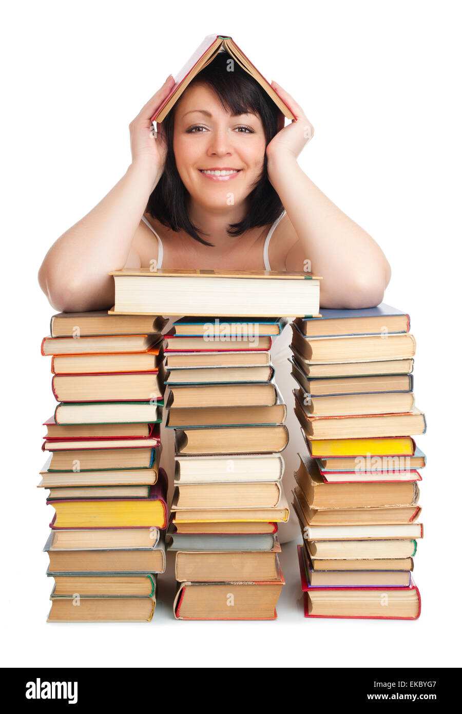 Young smiling woman with heap of books Stock Photo - Alamy