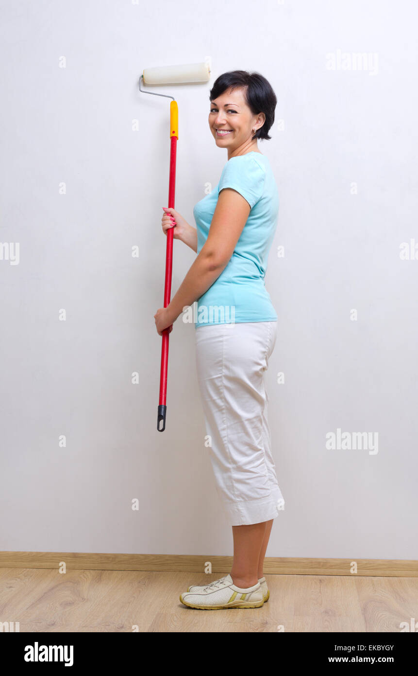 Woman with painting roller Stock Photo - Alamy