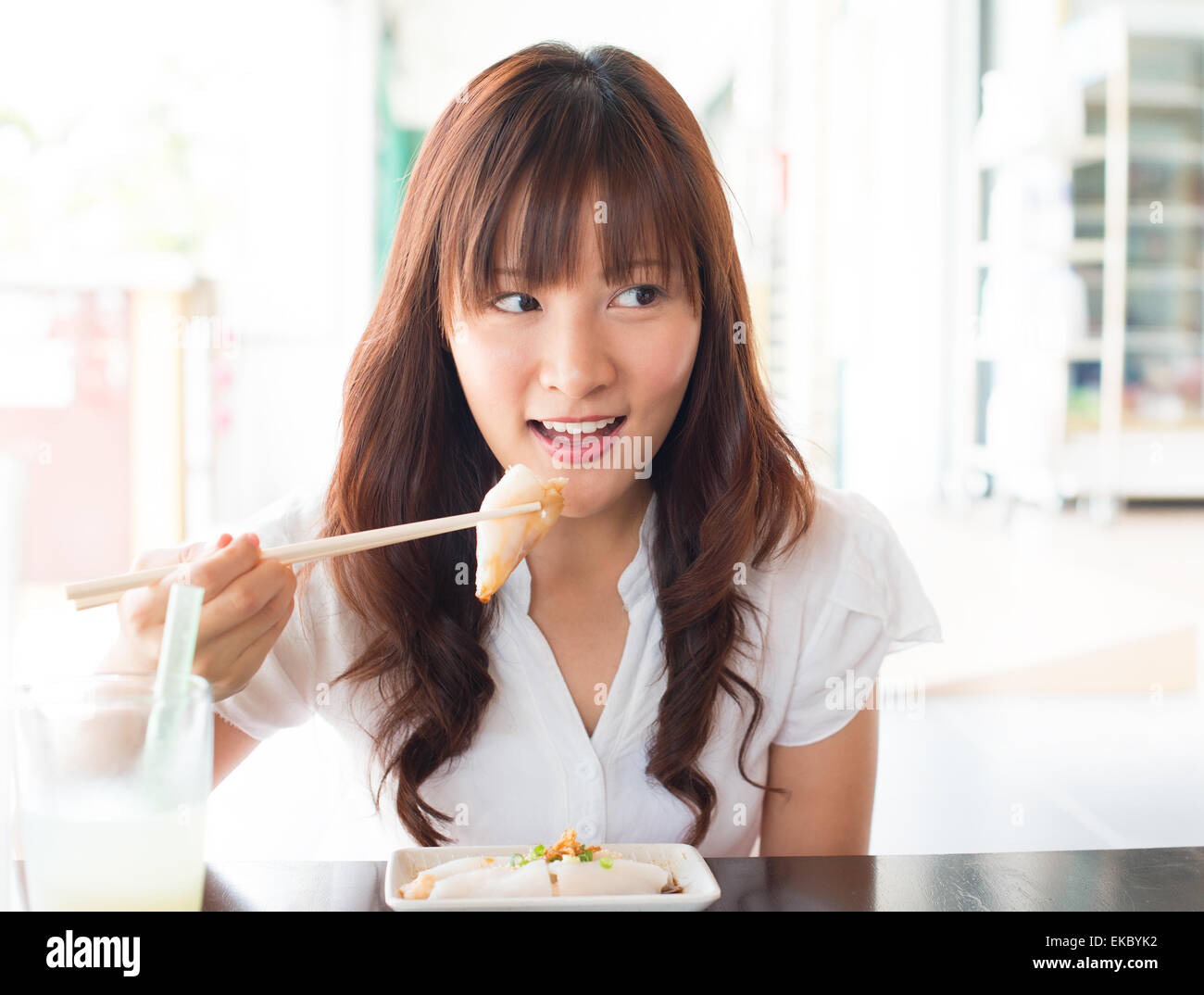 Asian girl eating dim sum Stock Photo - Alamy