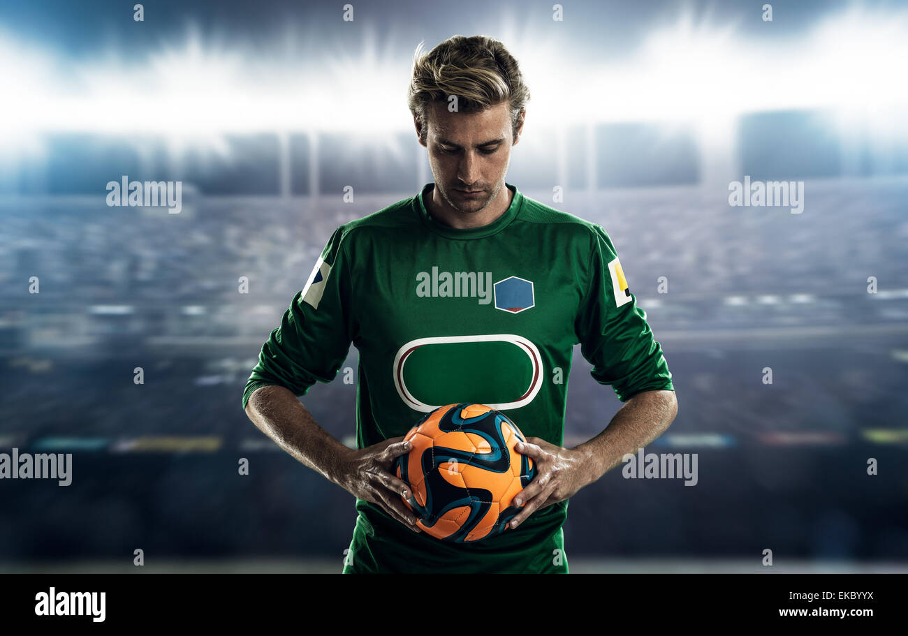 Footballer holding ball Stock Photo - Alamy