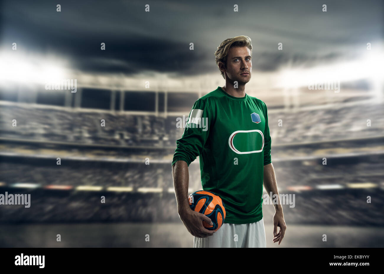 Footballer holding ball Stock Photo - Alamy
