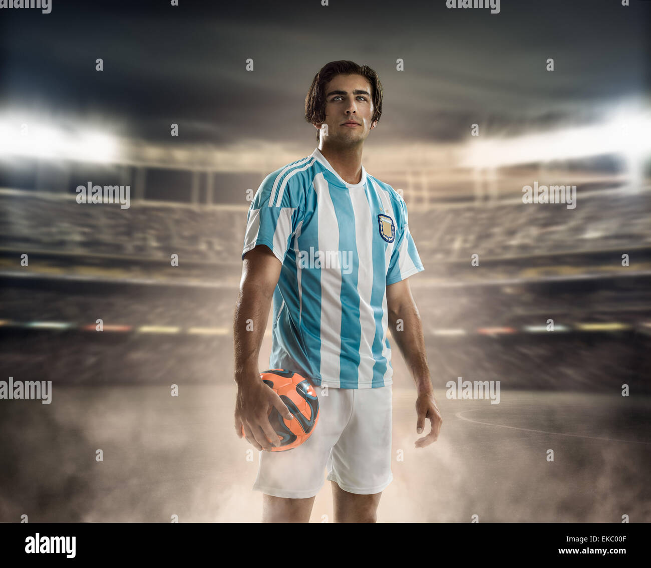 Footballer holding ball Stock Photo - Alamy