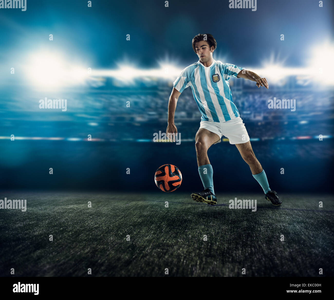 Footballer chasing ball Stock Photo - Alamy