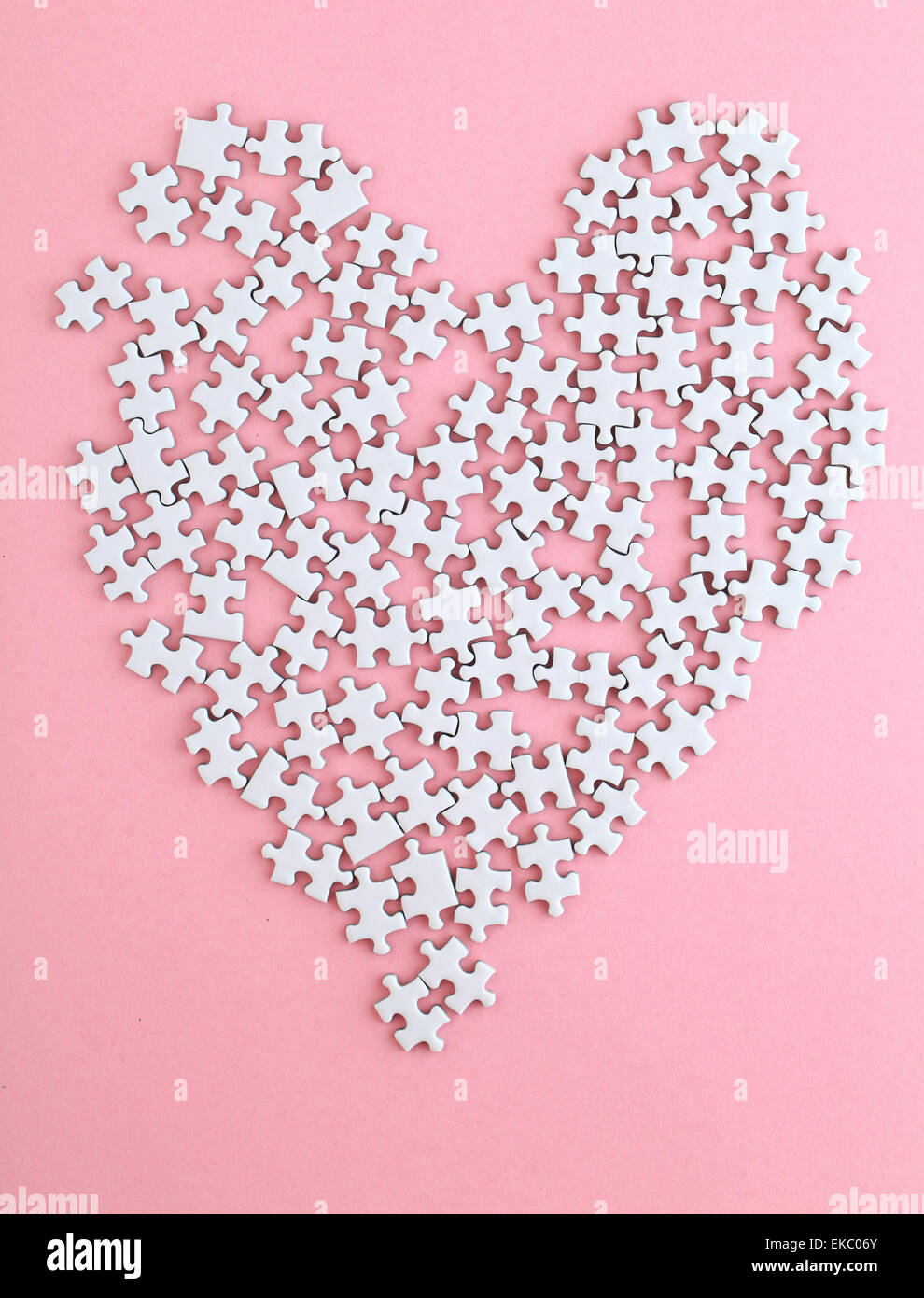 puzzle made heart shape on pink background Stock Photo - Alamy