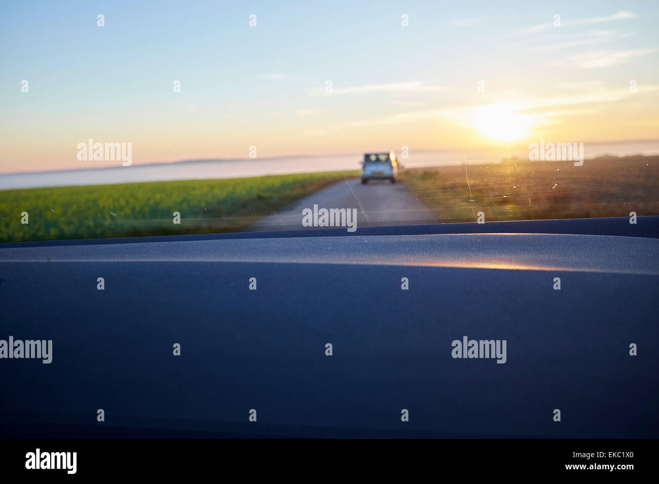 View through car windscreen of sunset at coast, Brittany, France Stock ...