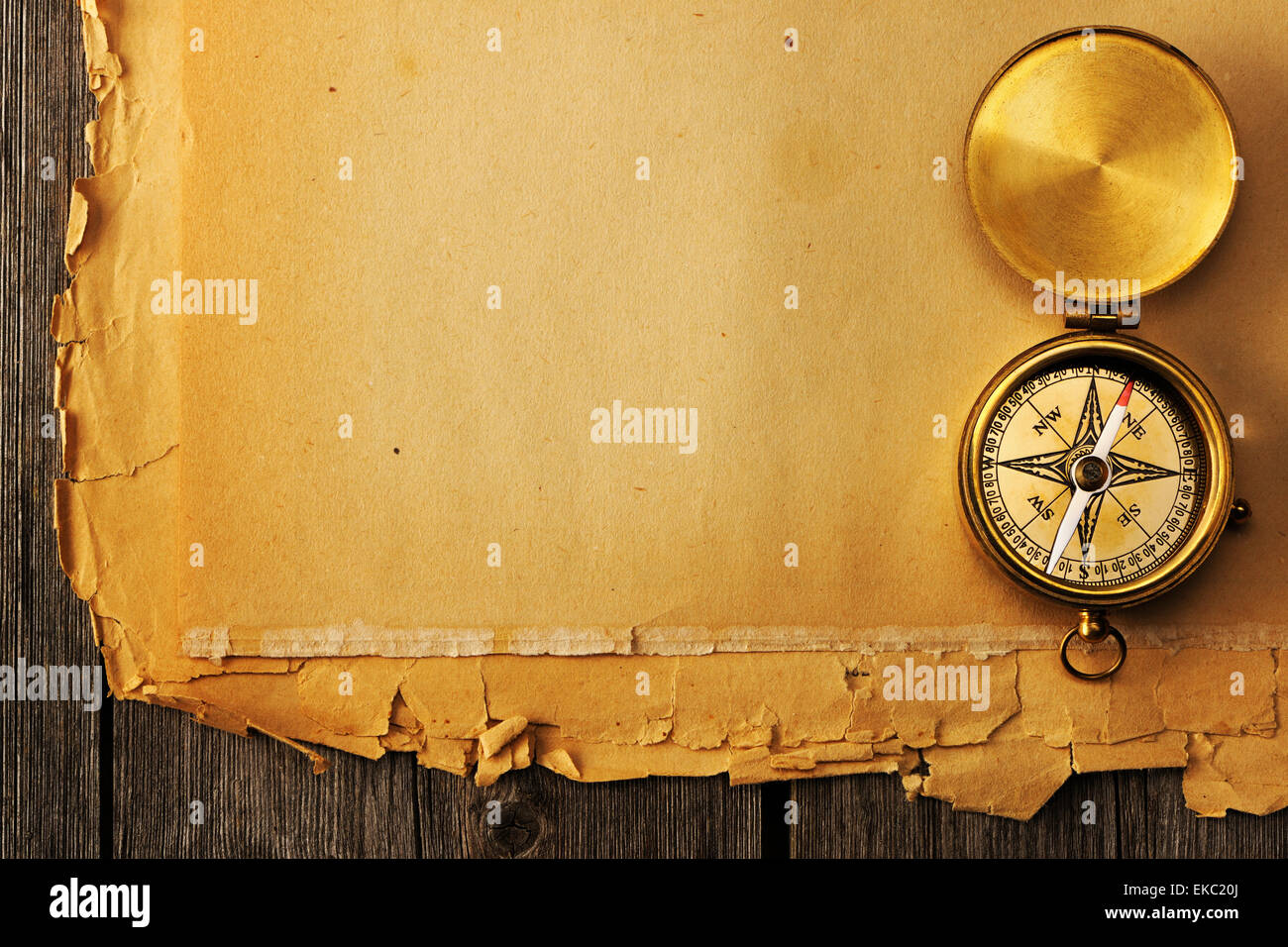 Antique brass compass over old background Stock Photo - Alamy
