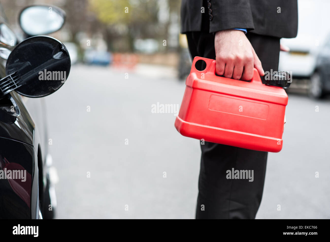 Man holding fuel can, cropped image Stock Photo - Alamy